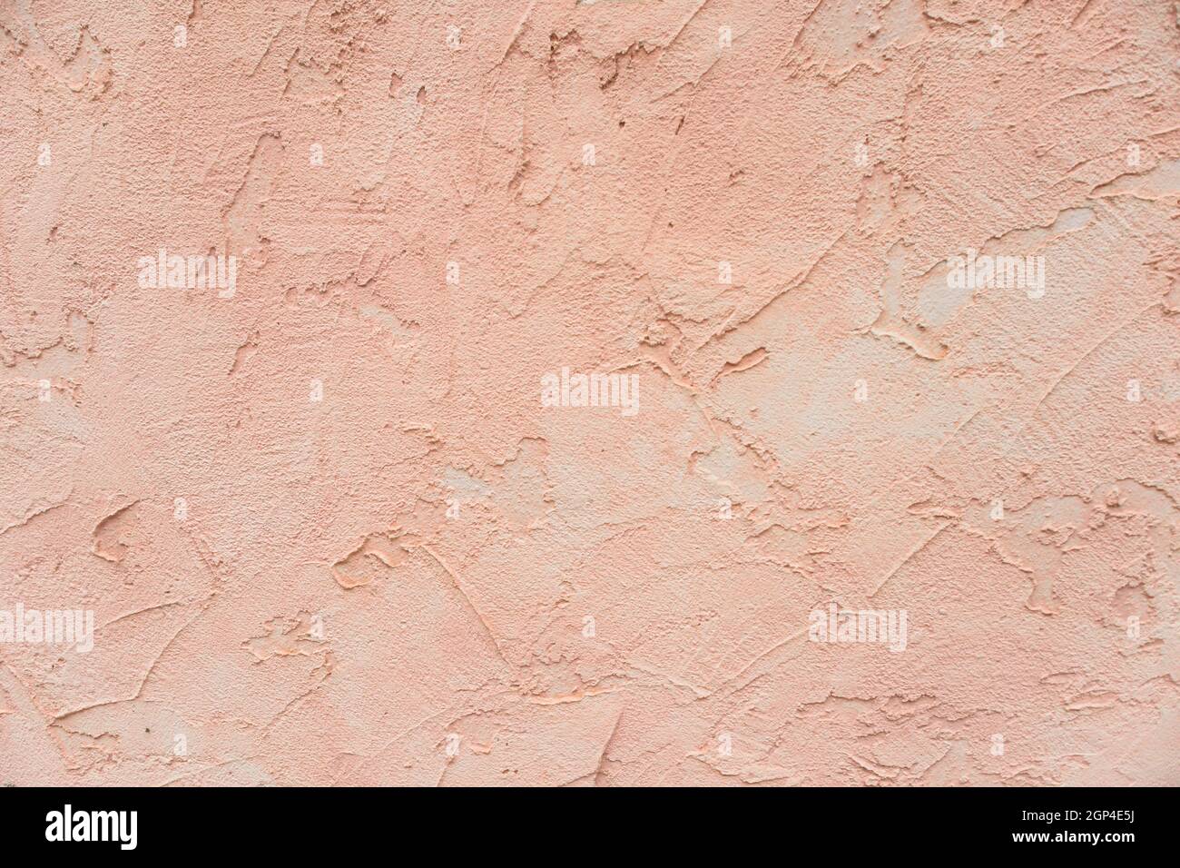 Detail of an exterior wall painted with a light pink embossed cladding ...