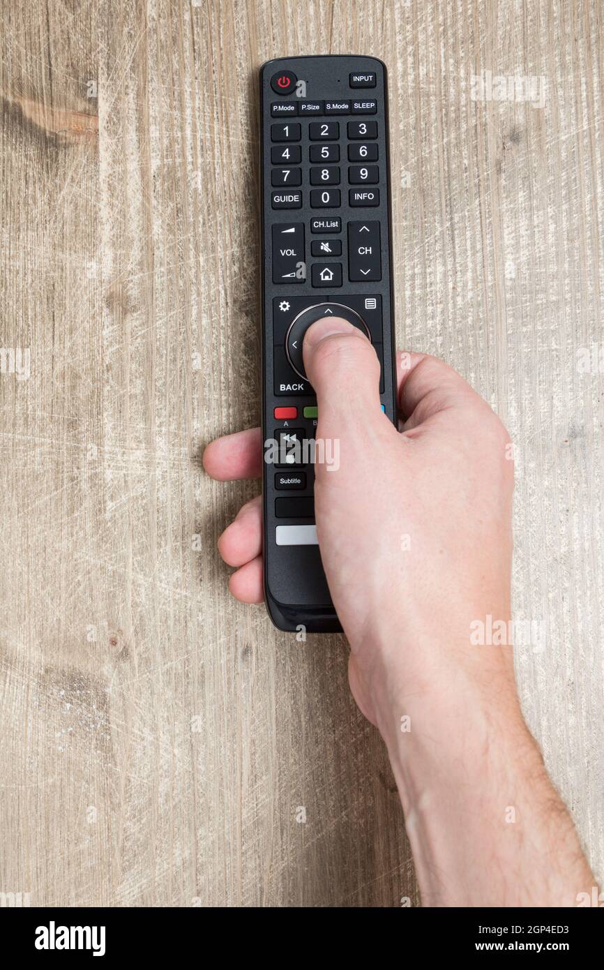Hand with Tv remote controller Stock Photo - Alamy