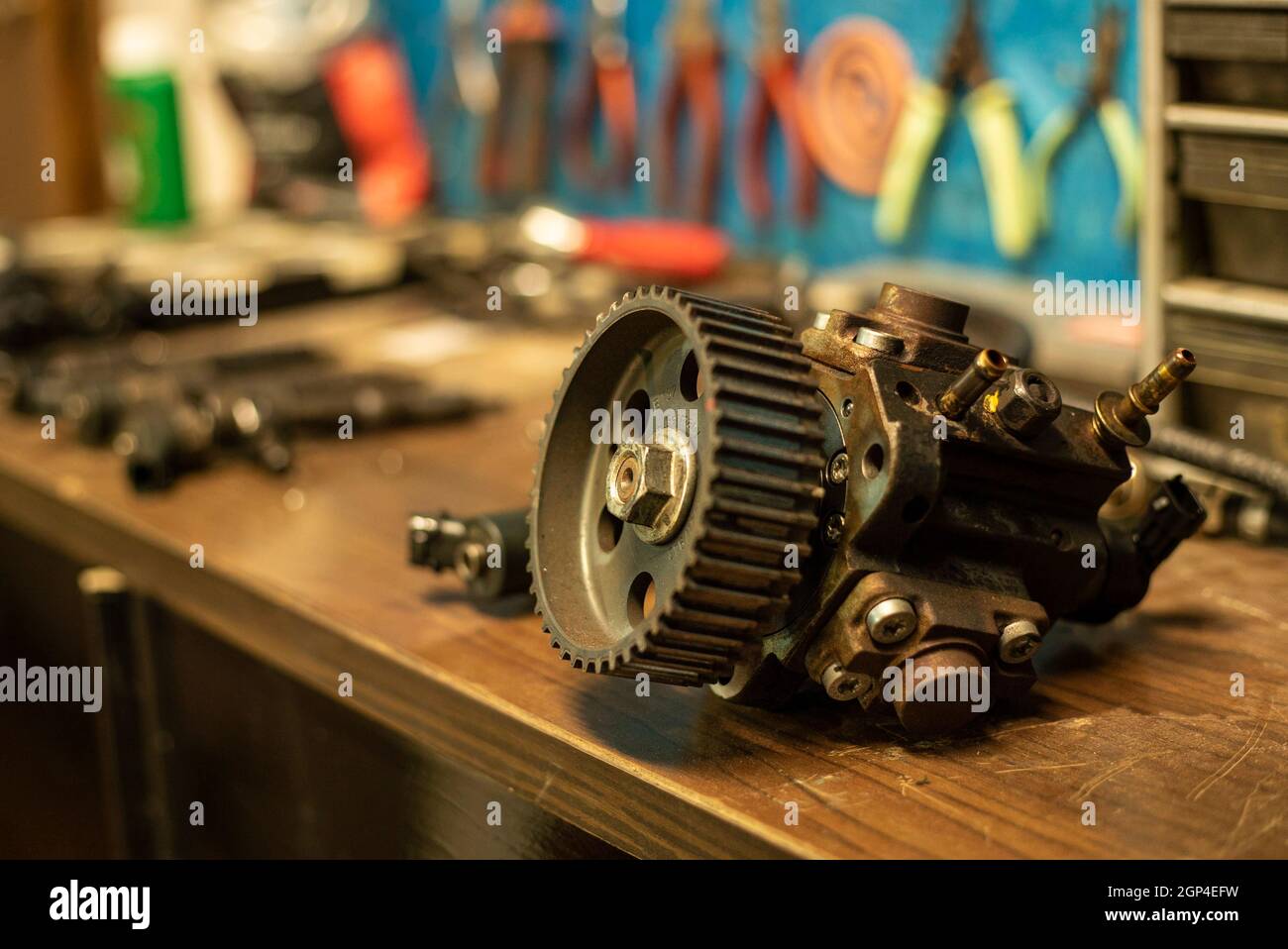 Spare car engine diesel pump resting on the mechanical workshop bench ...