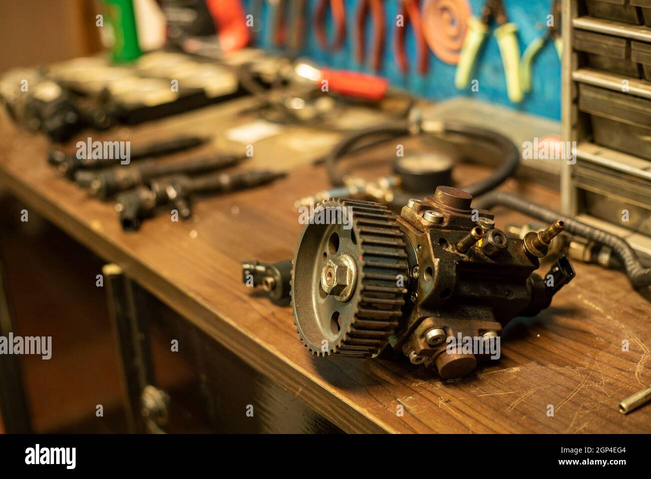 Spare car engine resting on the mechanical workshop bench Stock Photo ...