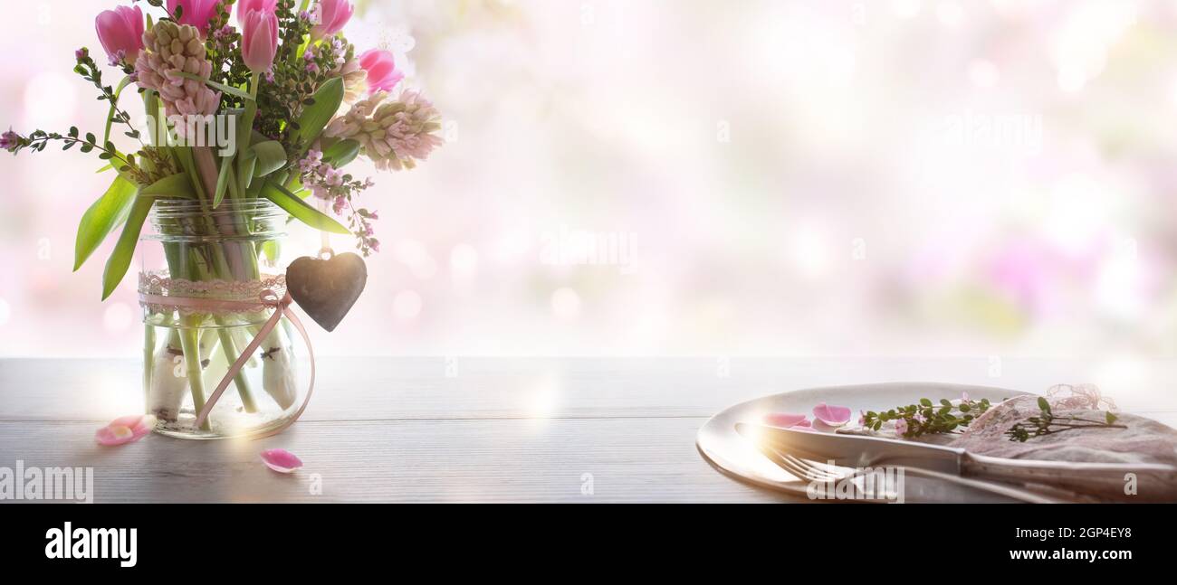 Table decorating with spring flowers and place setting for a wedding ...