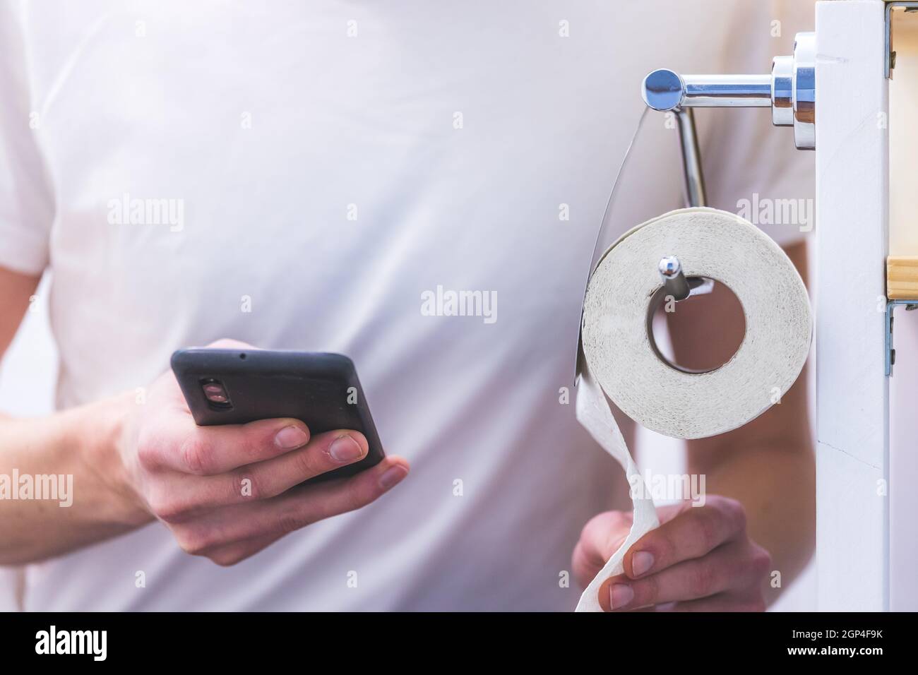 Young man sitting on toilet hi-res stock photography and images - Alamy