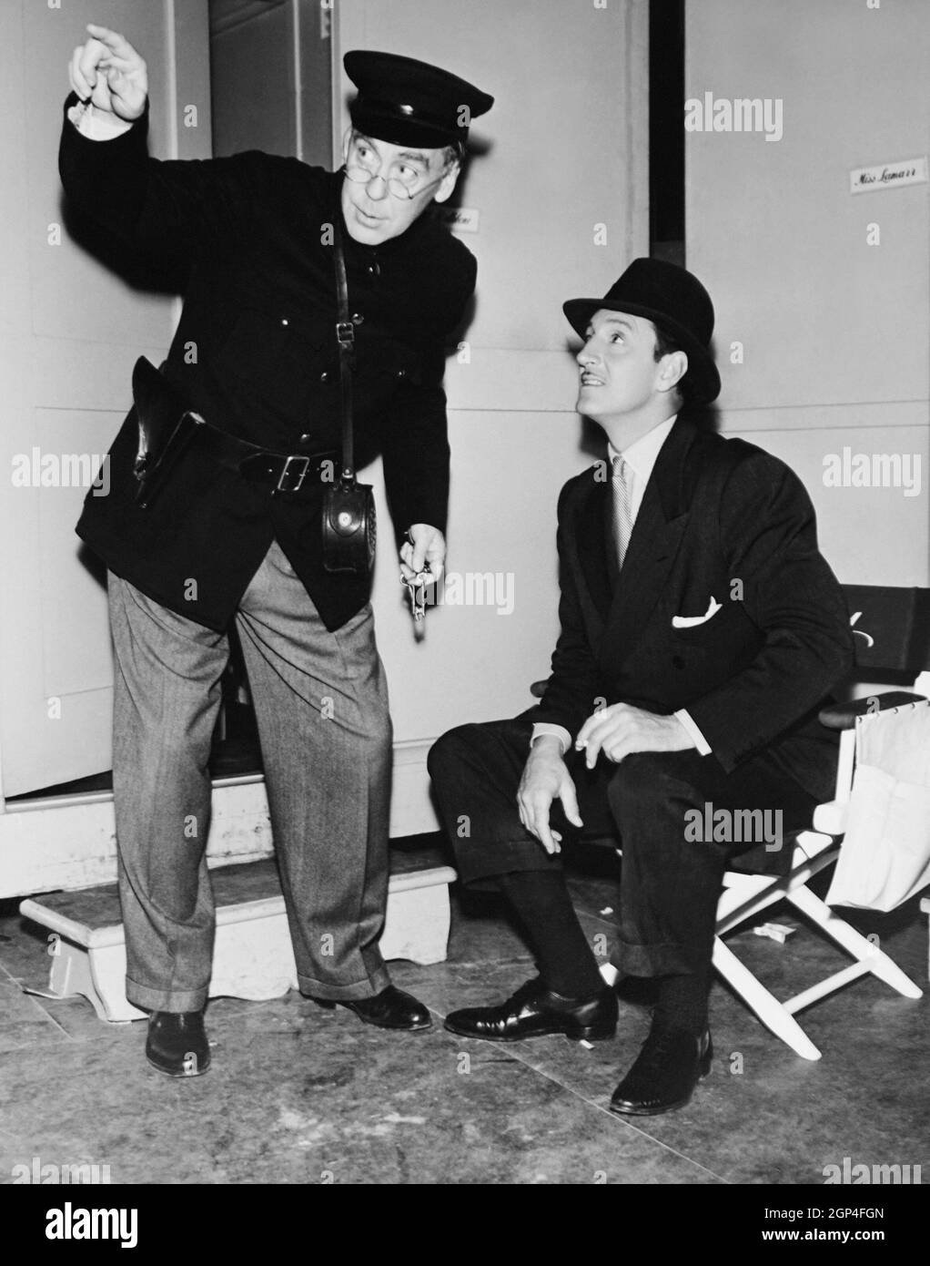 CROSSROADS, from left: director Jack Conway, Basil Rathbone on set ...