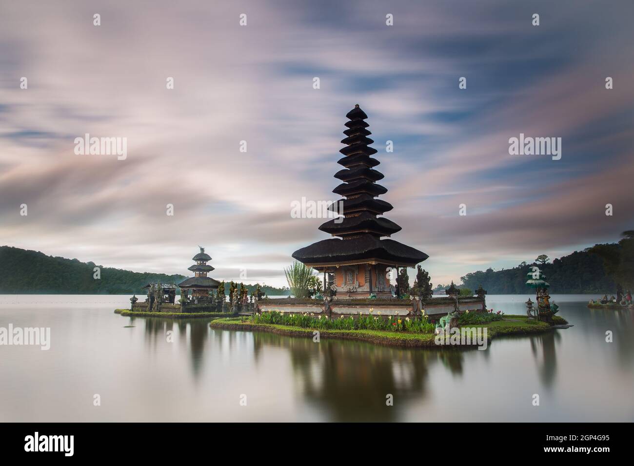 INDONESIA, BALI. SUNRISE OVER THE ULUN DANU TEMPLE ON THE BRATAN LAKE ...