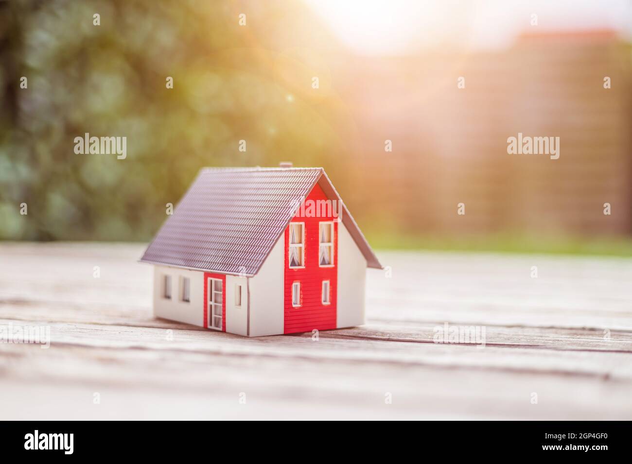 Red house model on the floor, outdoors. Concept for new home, property ...