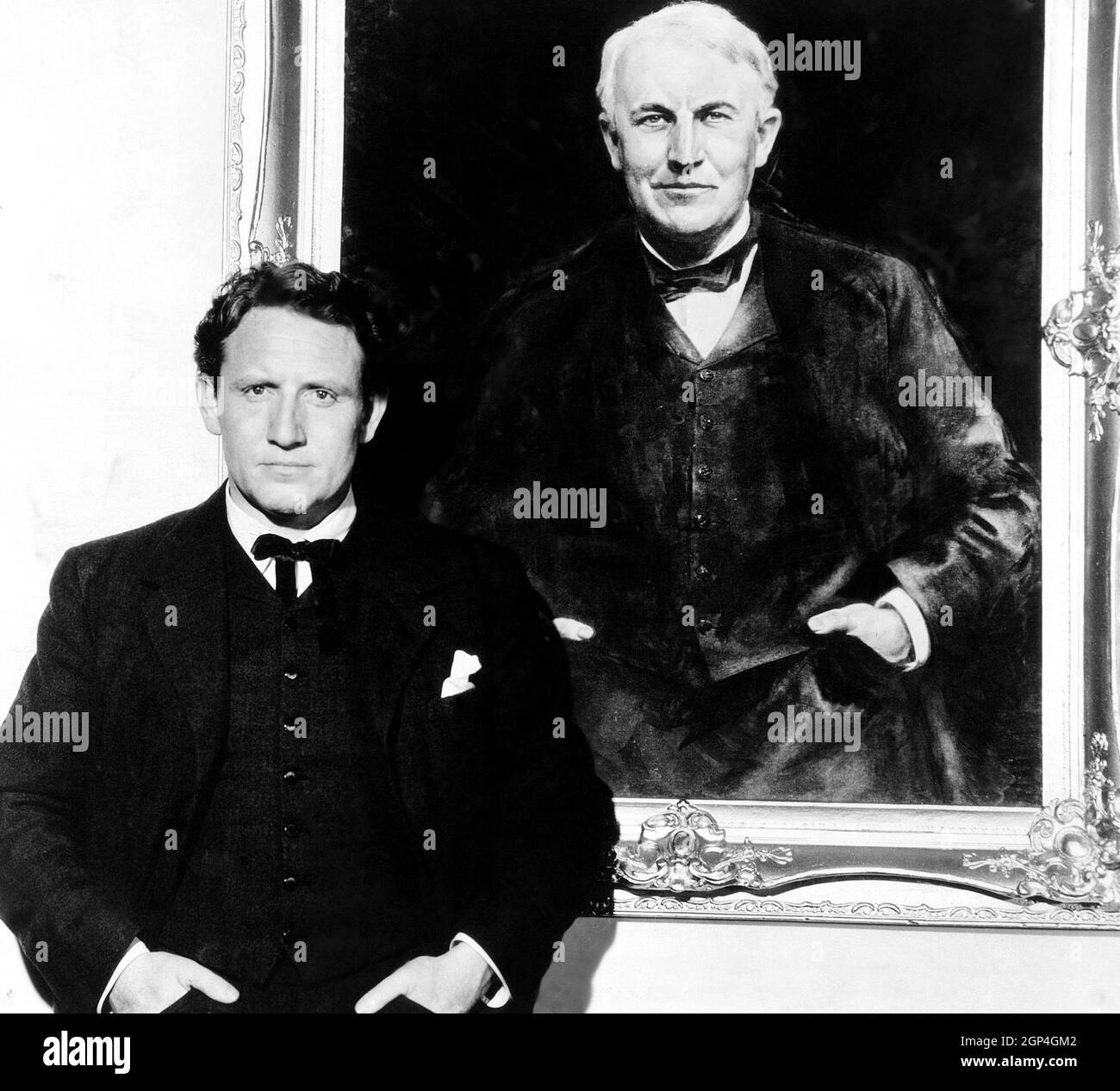 EDISON, THE MAN, Spencer Tracy, on-set with a portrait of Thomas Edison ...
