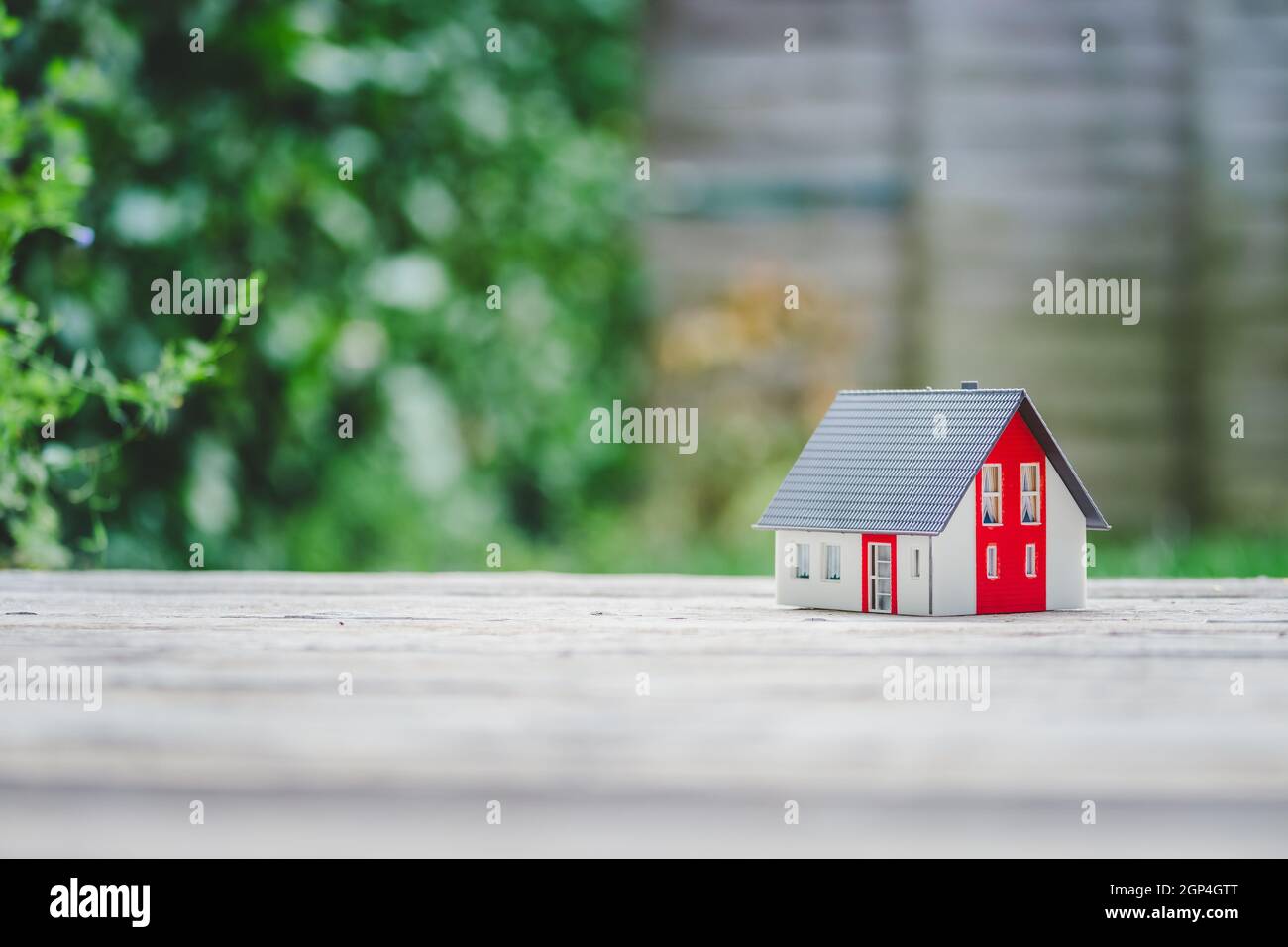 Red house model on the floor, outdoors. Concept for new home, property ...