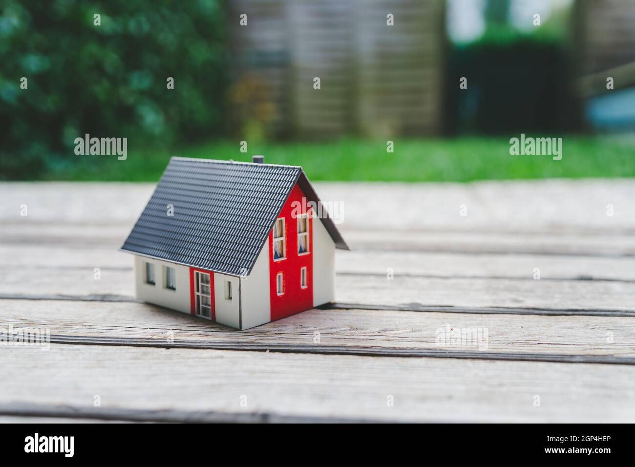 Red house model on the floor, outdoors. Concept for new home, property ...