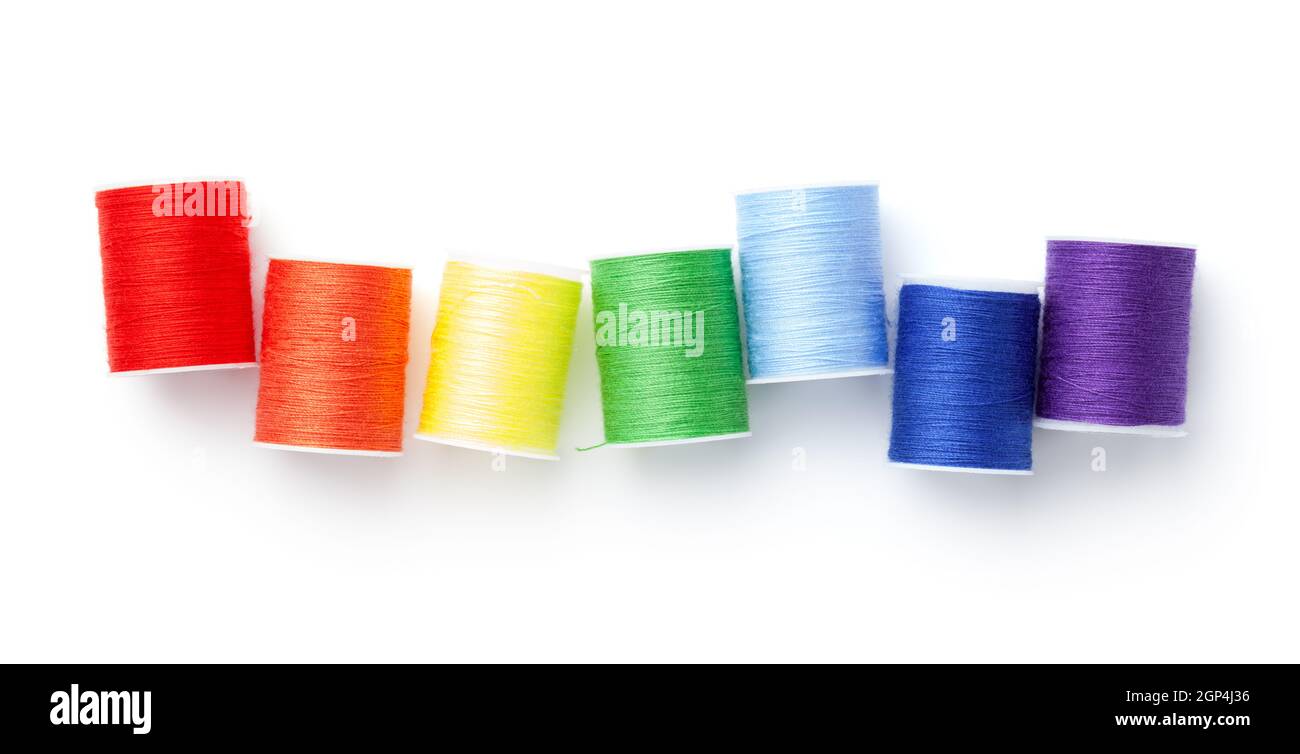 Sewing threads arranged like rainbow colors isolated on white ...