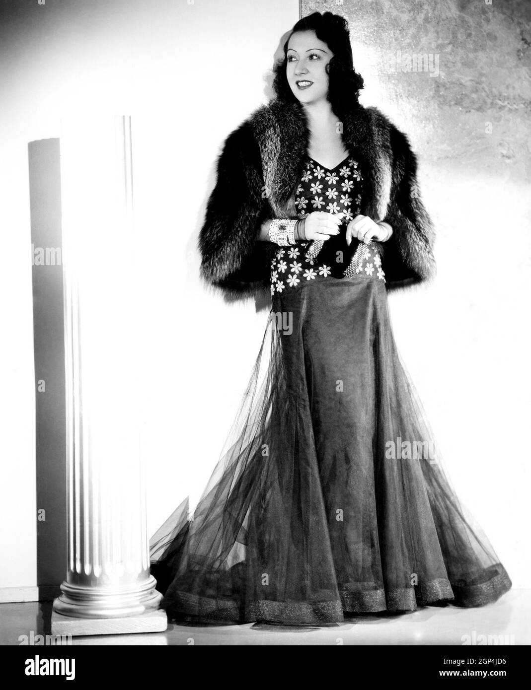 HAPPY LANDING, Ethel Merman, in a black net evening gown and silver fox ...