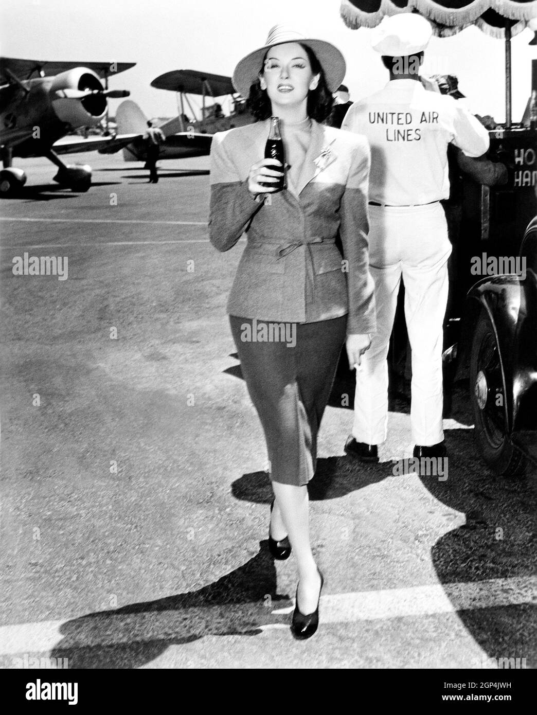 HIRED WIFE, Rosalind Russell, enjoying a refreshing soda between takes ...