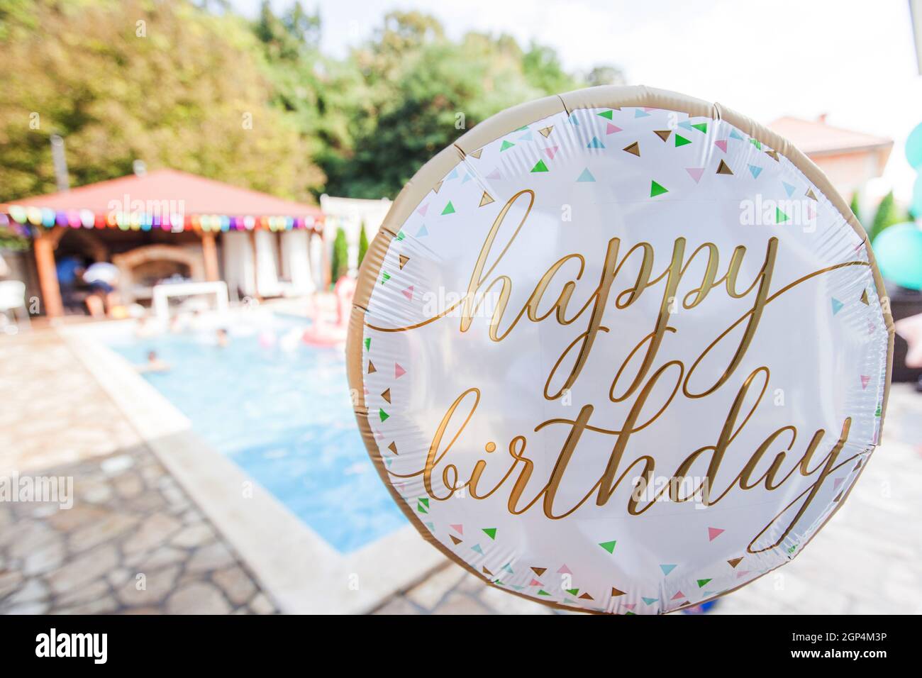 Birthday decoration. The balloon with Happy Birthday wishes at the pool ...
