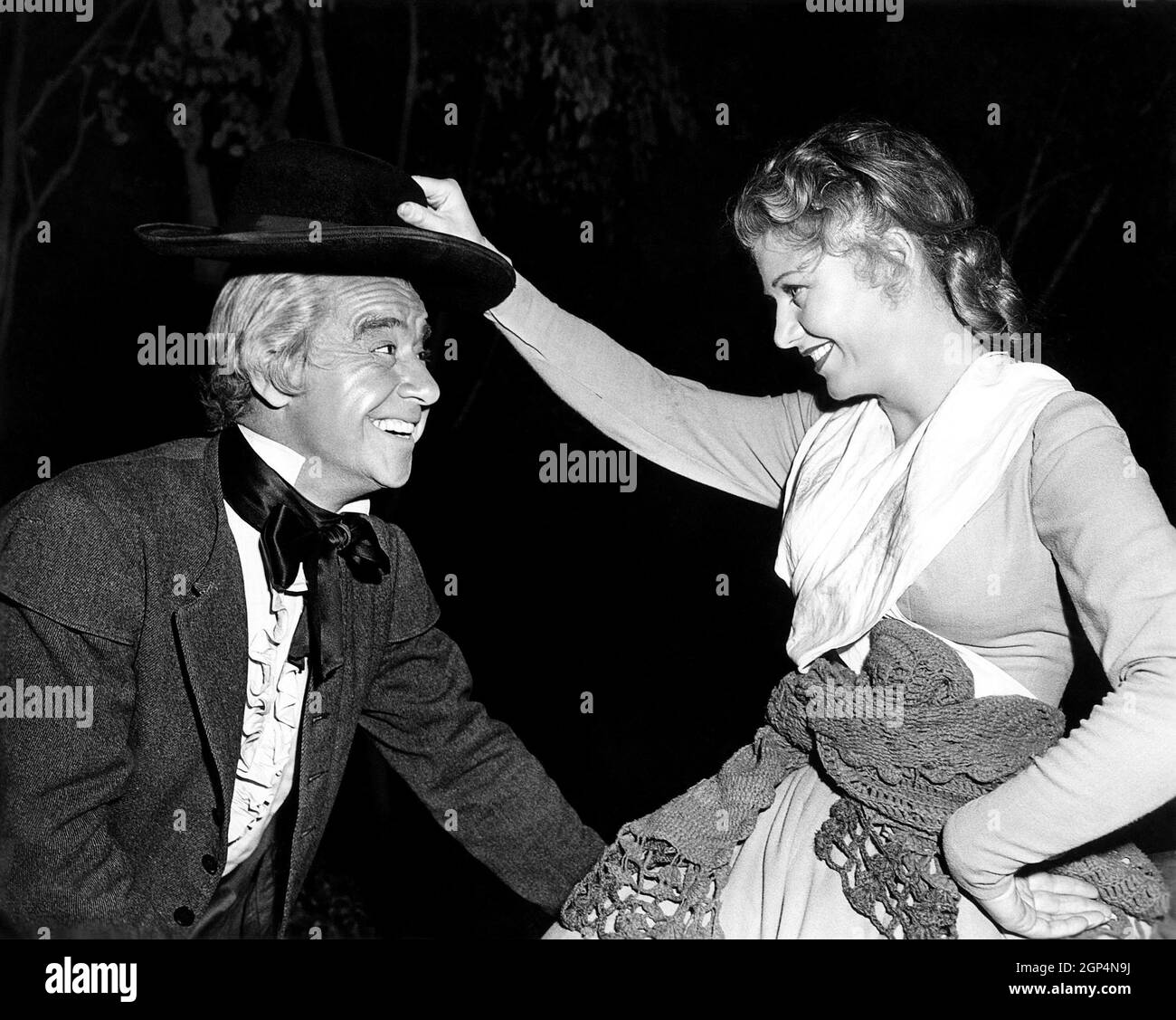 MAGNIFICENT DOLL, Ginger Rogers, being visited on-set by actor Johnny ...