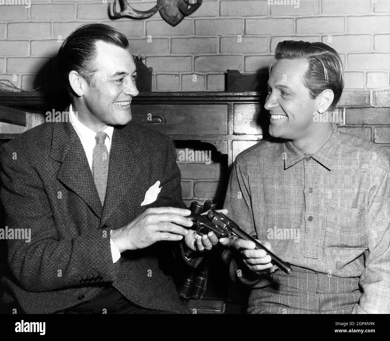 THE MAN FROM COLORADO, Charles Starrett, left, making one of his many ...