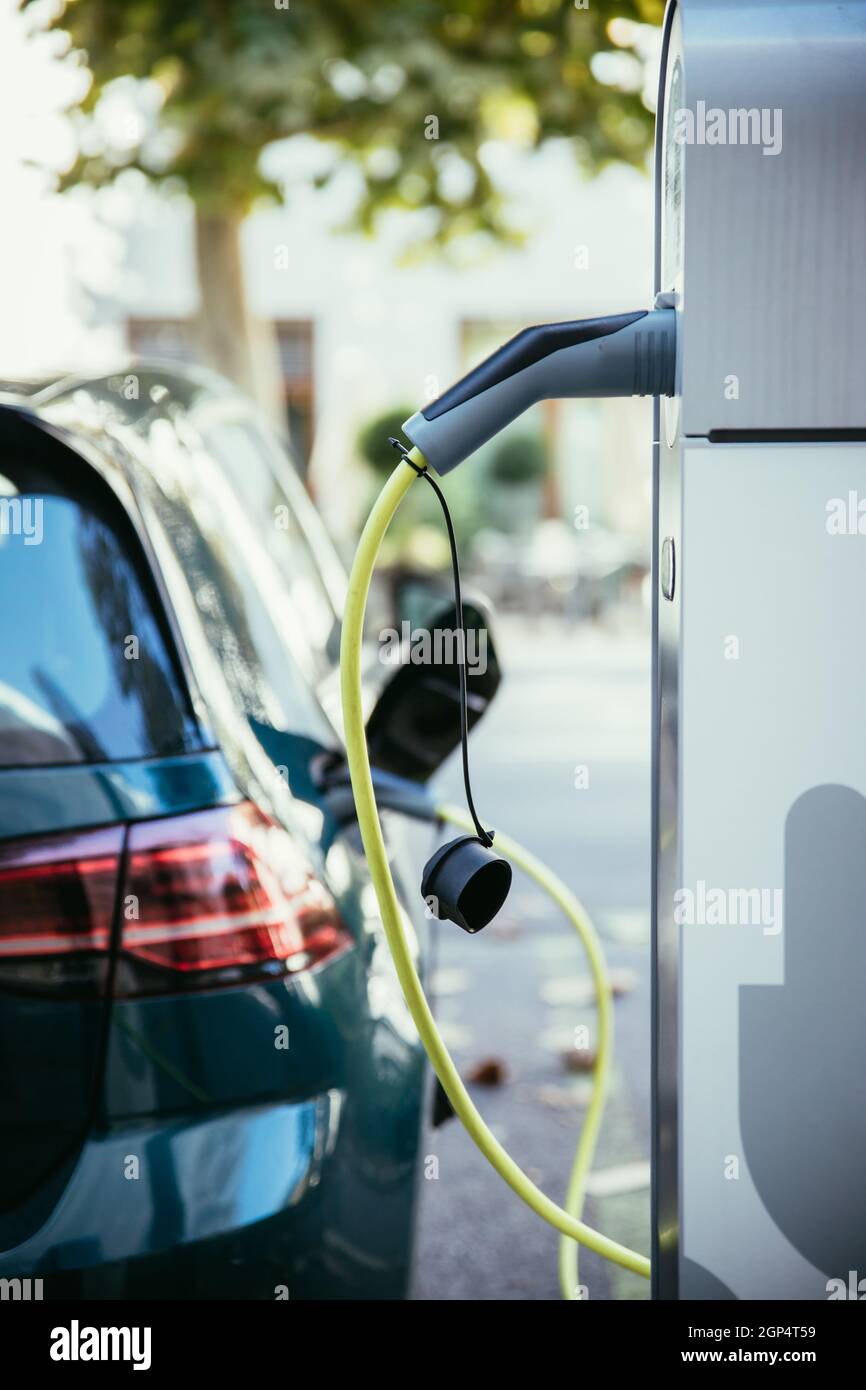 Electric car recharging with charge cable and plug leading to charge ...