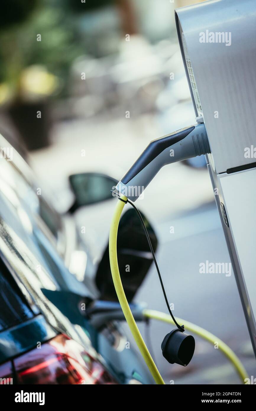 Electric car recharging with charge cable and plug leading to charge ...