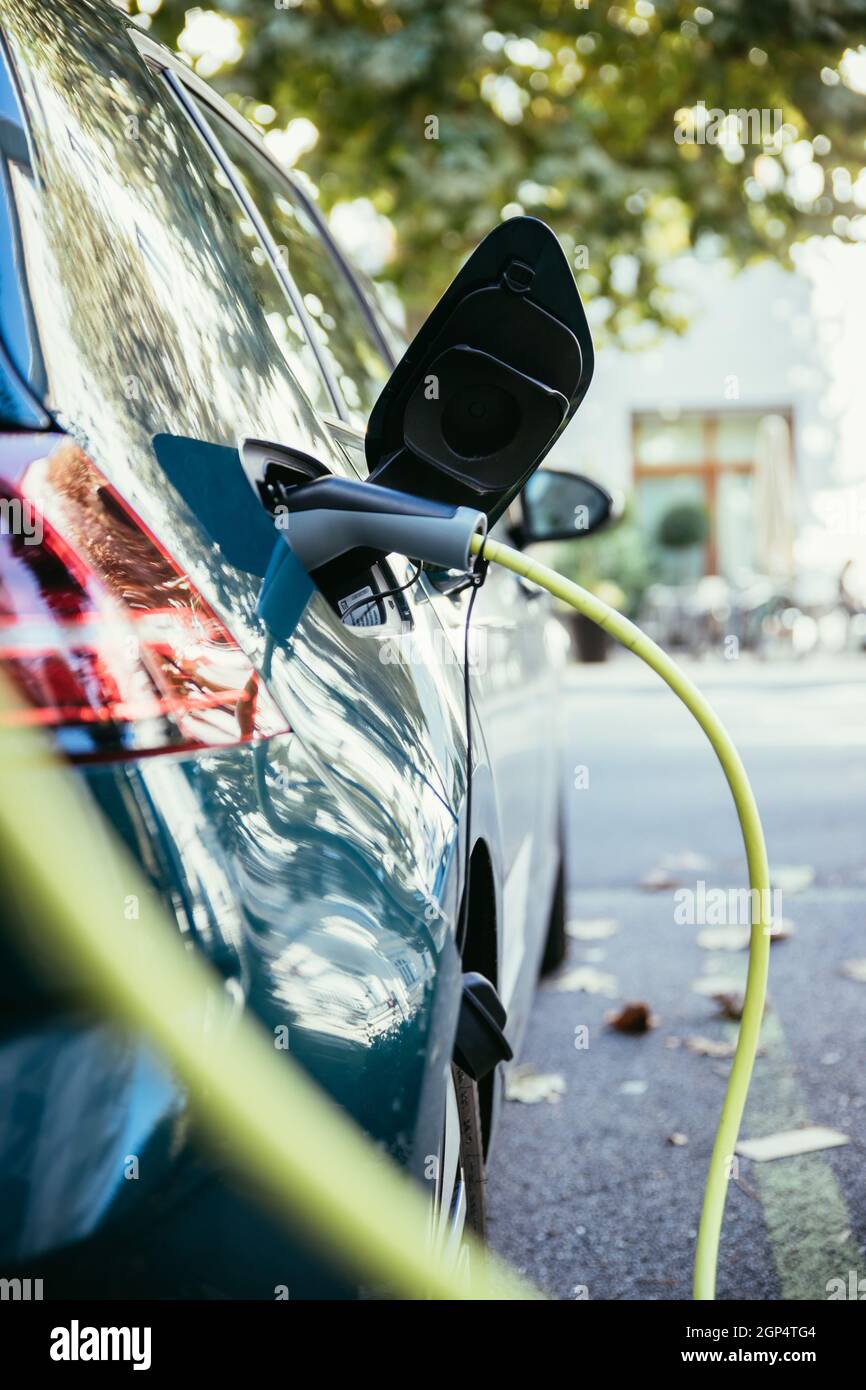 Electric car recharging with charge cable and plug leading to charge ...