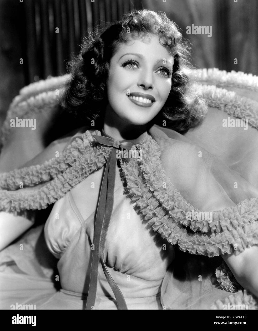 PRIVATE NUMBER, Loretta Young, in a blue starched highly ruched dress ...