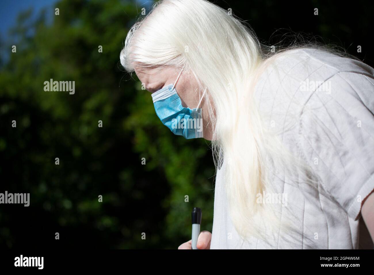 Close up of an albino woman wearing a medical mask Stock Photo - Alamy
