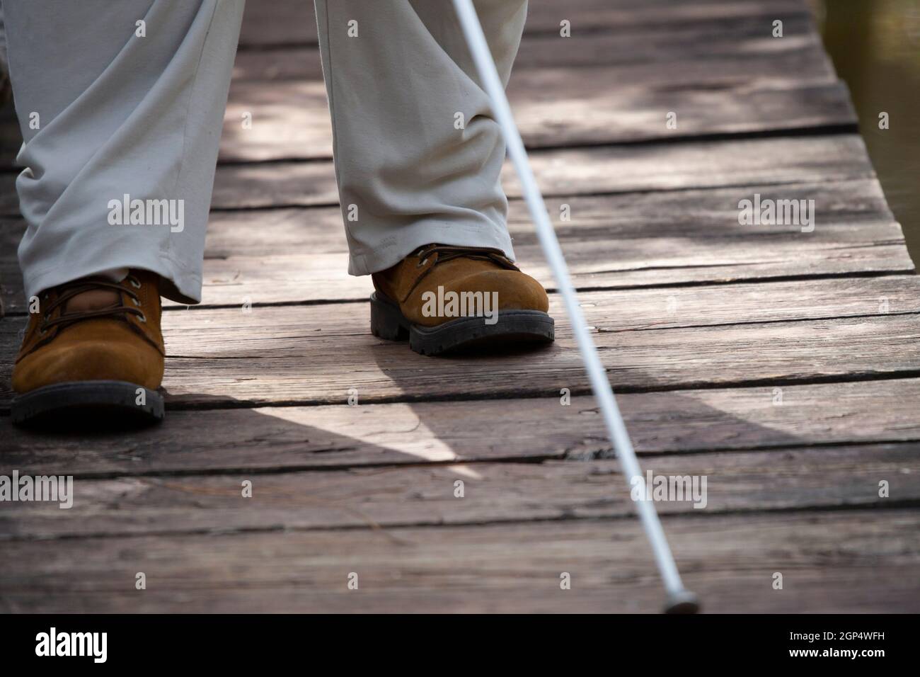 Blind woman standing on a bridge over water Stock Photo - Alamy