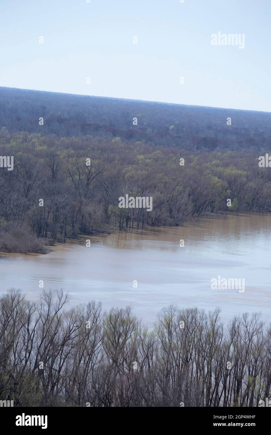 River bank lined with trees in the distance Stock Photo - Alamy