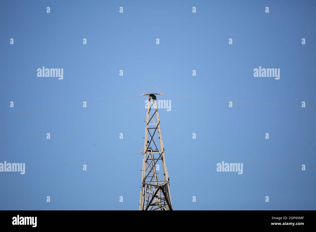 Top of an electrical tower and its wires Stock Photo - Alamy