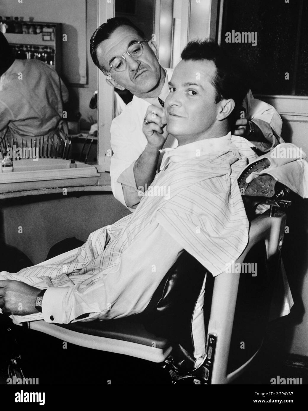 SABOTEUR, from left: makeup artist Jack Pierce preparing Alan Baxter on ...
