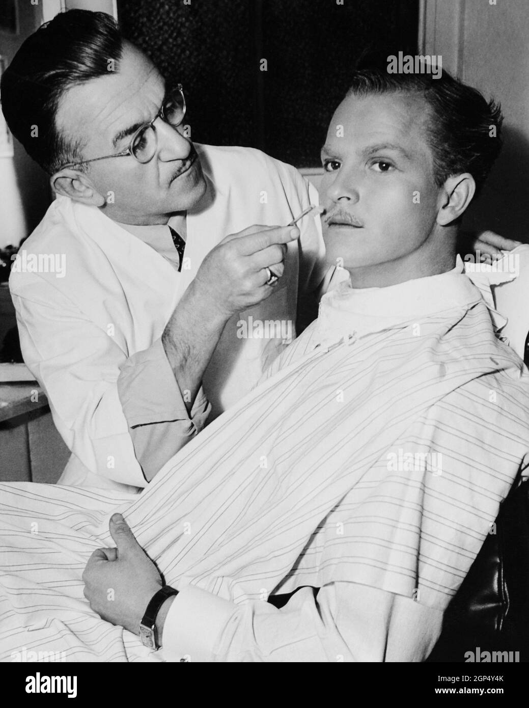 SABOTEUR, from left: makeup artist Jack Pierce preparing Alan Baxter on ...