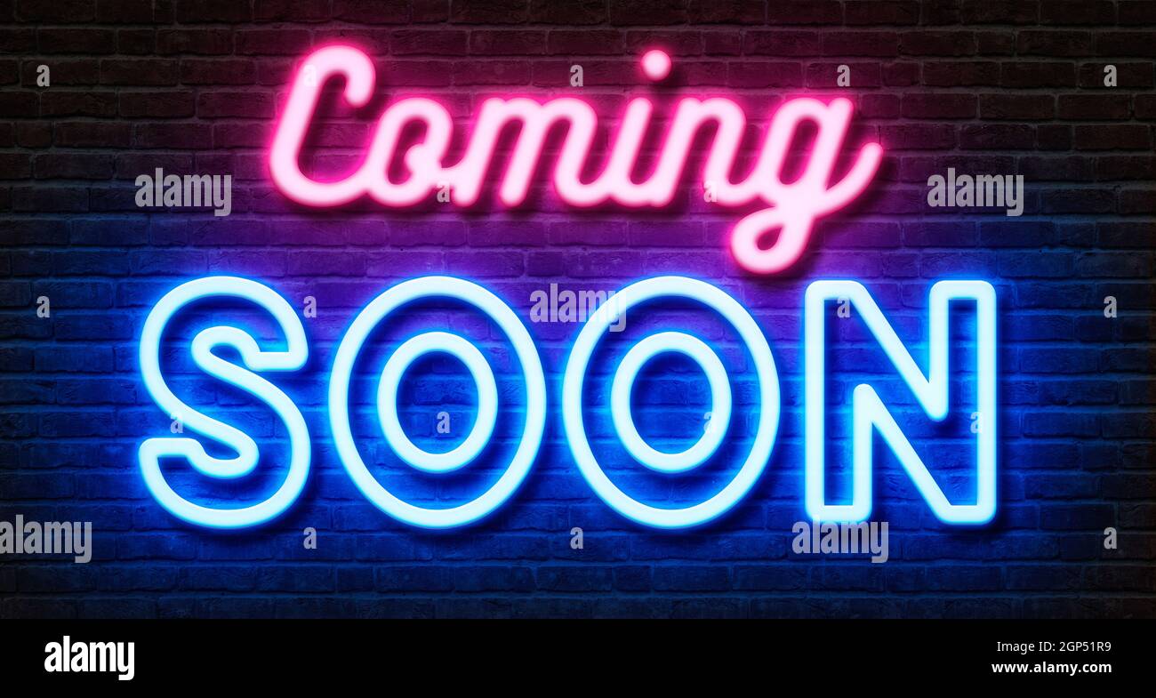 Neon sign on a brick wall - Coming soon Stock Photo - Alamy