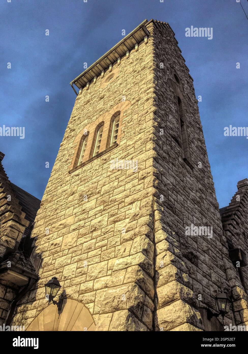 Vertical low angle shot of a beautiful stone tower with a clear blue ...