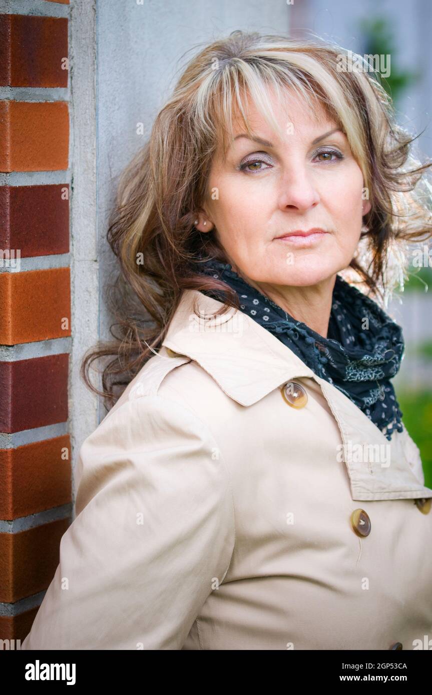 Side head-and-shoulder portrait of a middle-aged woman with her back ...