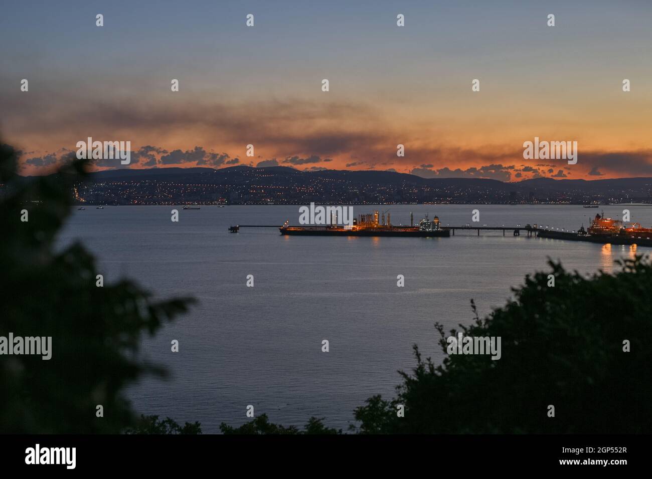 Calm sunset at the seaside, calm at sea. Clouds over the water surface ...