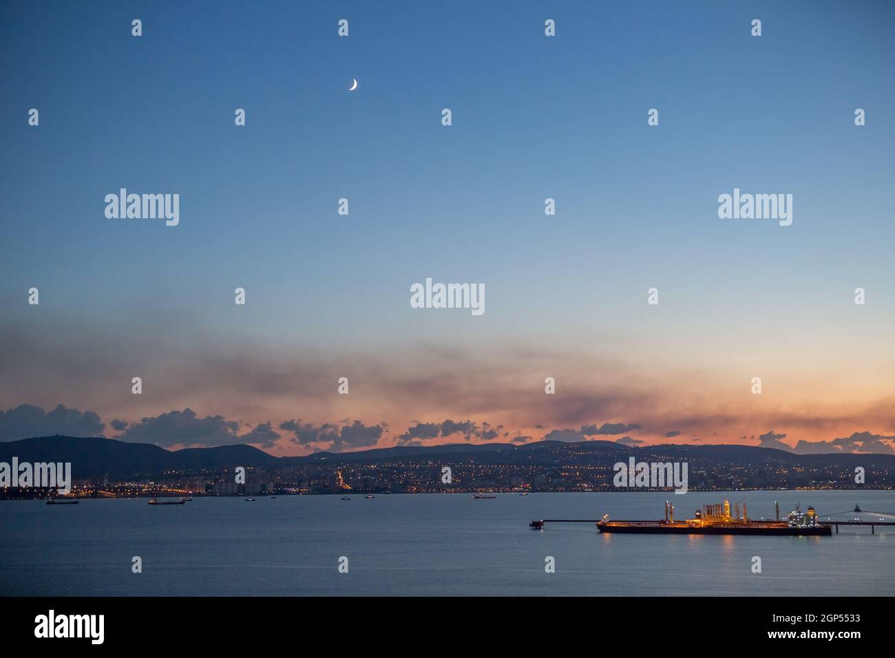 Calm sunset at the seaside, calm at sea. Clouds over the water surface ...