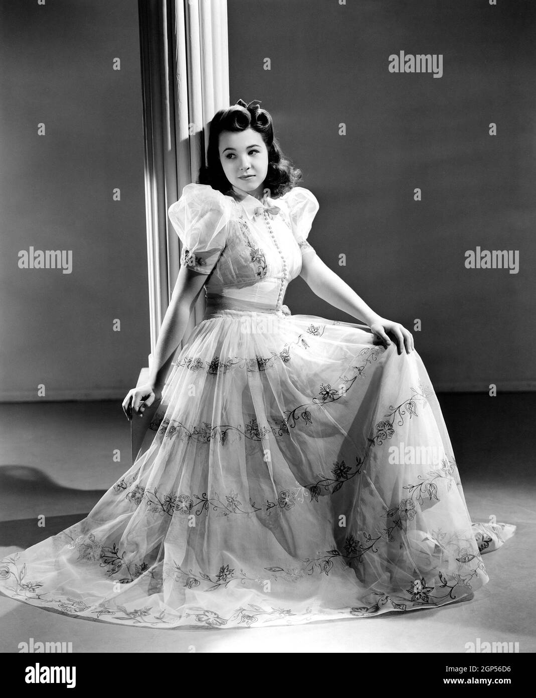 A Very Young Lady Jane Withers Modeling A Prom Gown With Rose Green