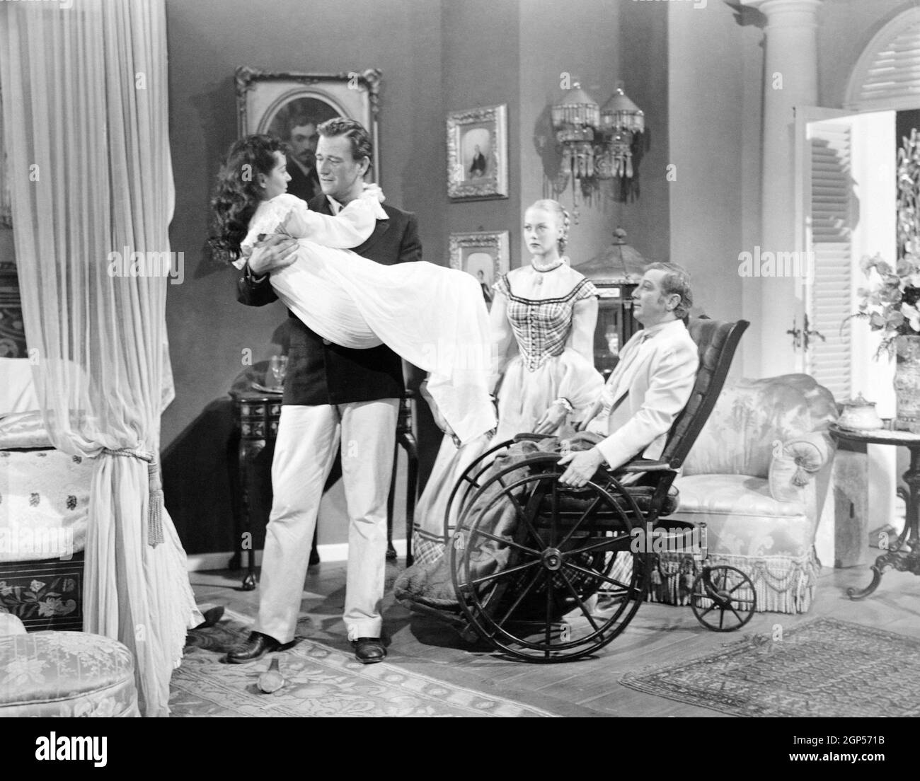 WAKE OF THE RED WITCH, from left, John Wayne (carrying Gail Russell ...