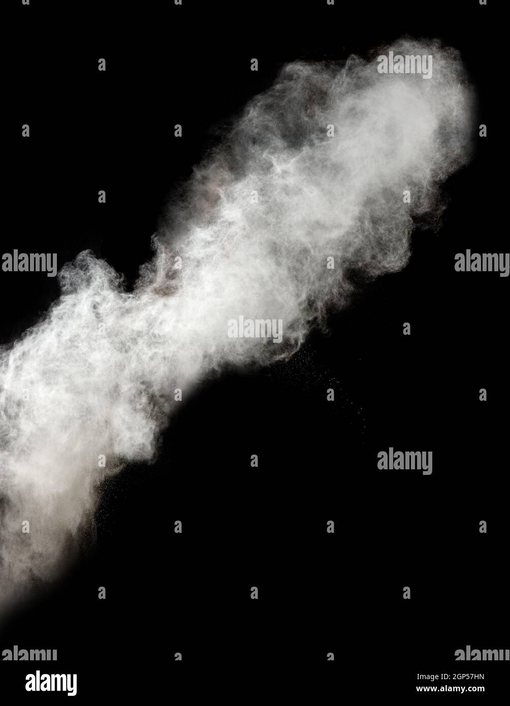 cloud of white wheat flour on a black background, particles fly in ...