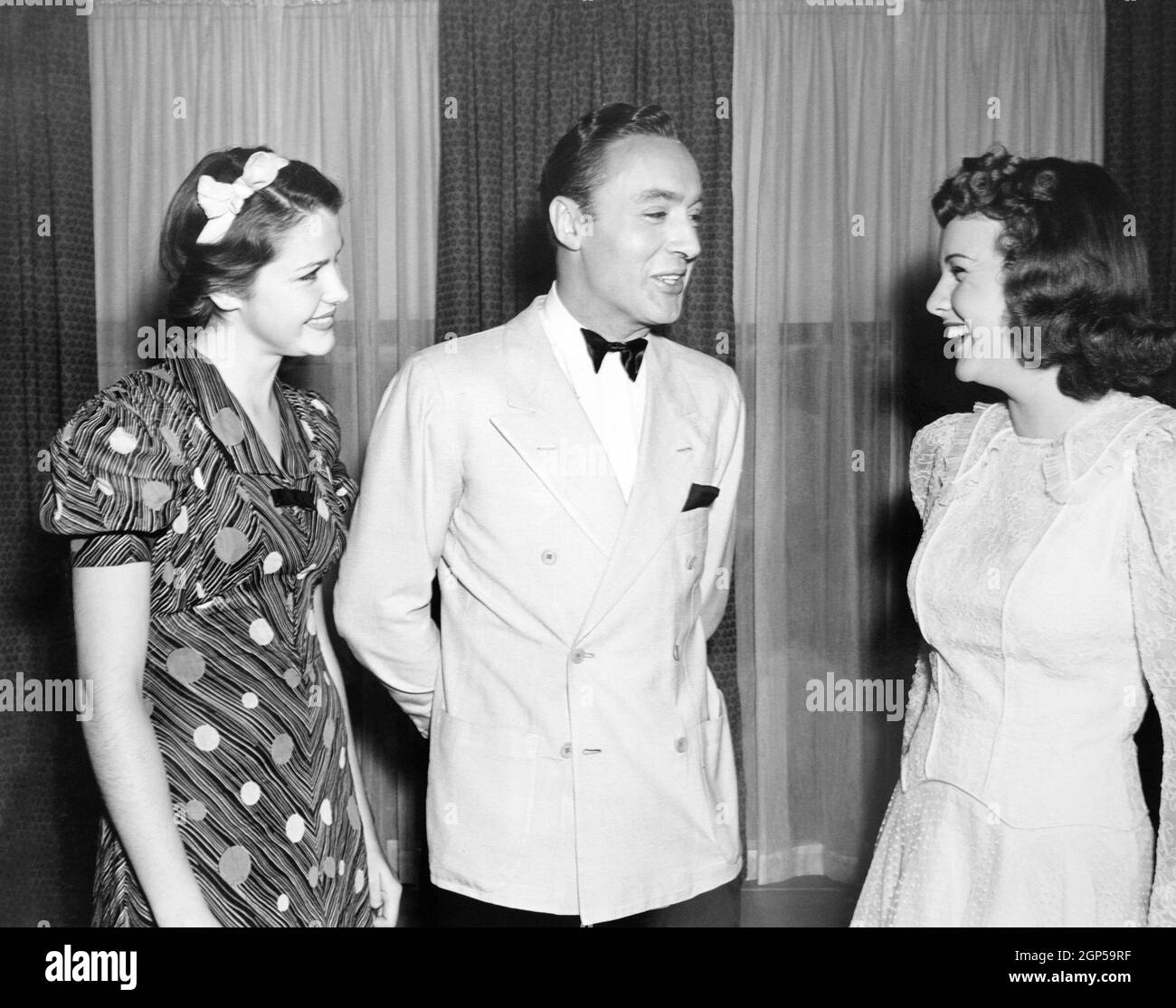Charles Boyer (who is making WHEN TOMORROW COMES) visits Helen Parrish ...
