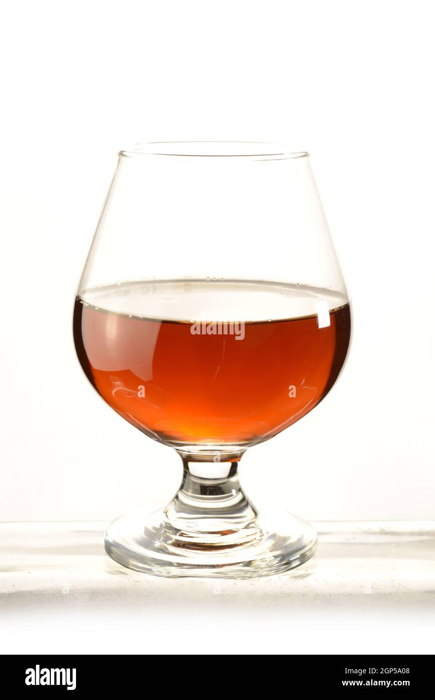A glass of Cognac over a white background Stock Photo - Alamy