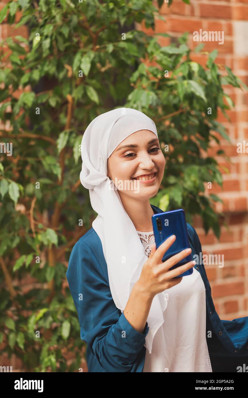 Muslim woman taking selfie. Happy beautiful girl with scarf take ...
