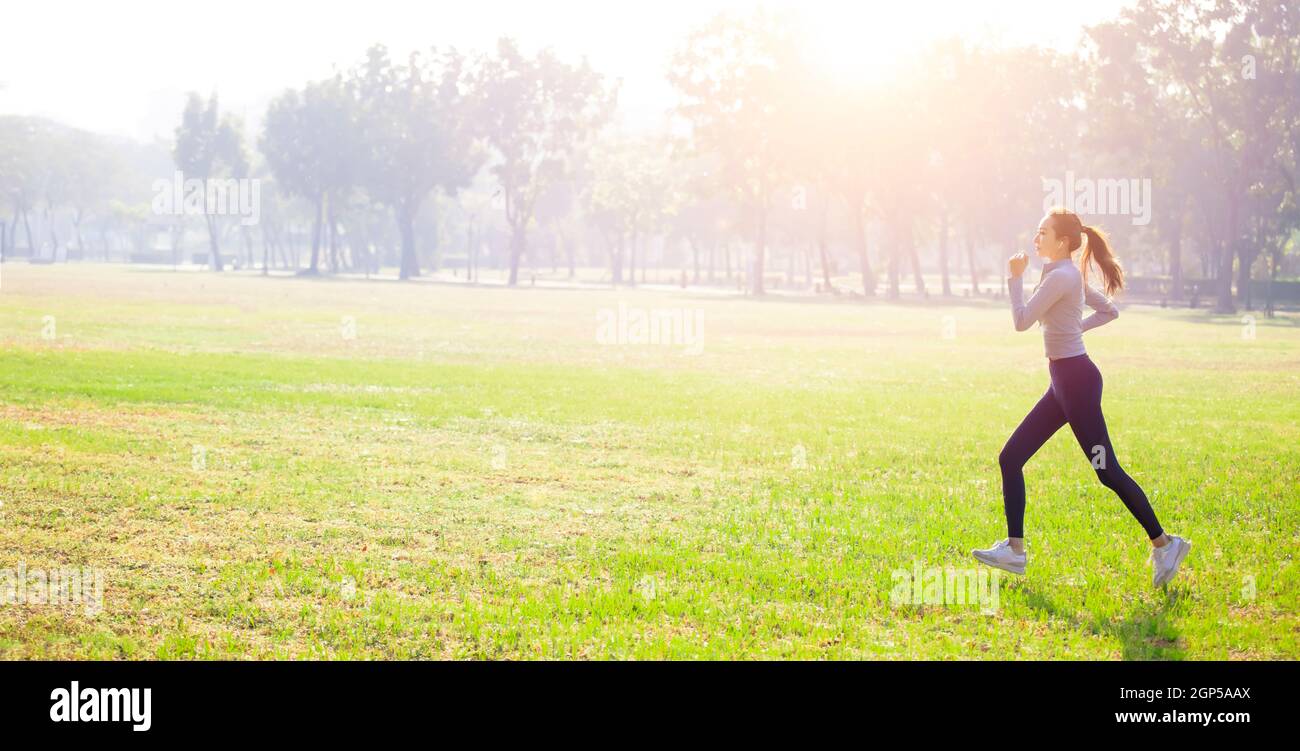 Young beautiful woman running on grass field at morning Stock Photo - Alamy