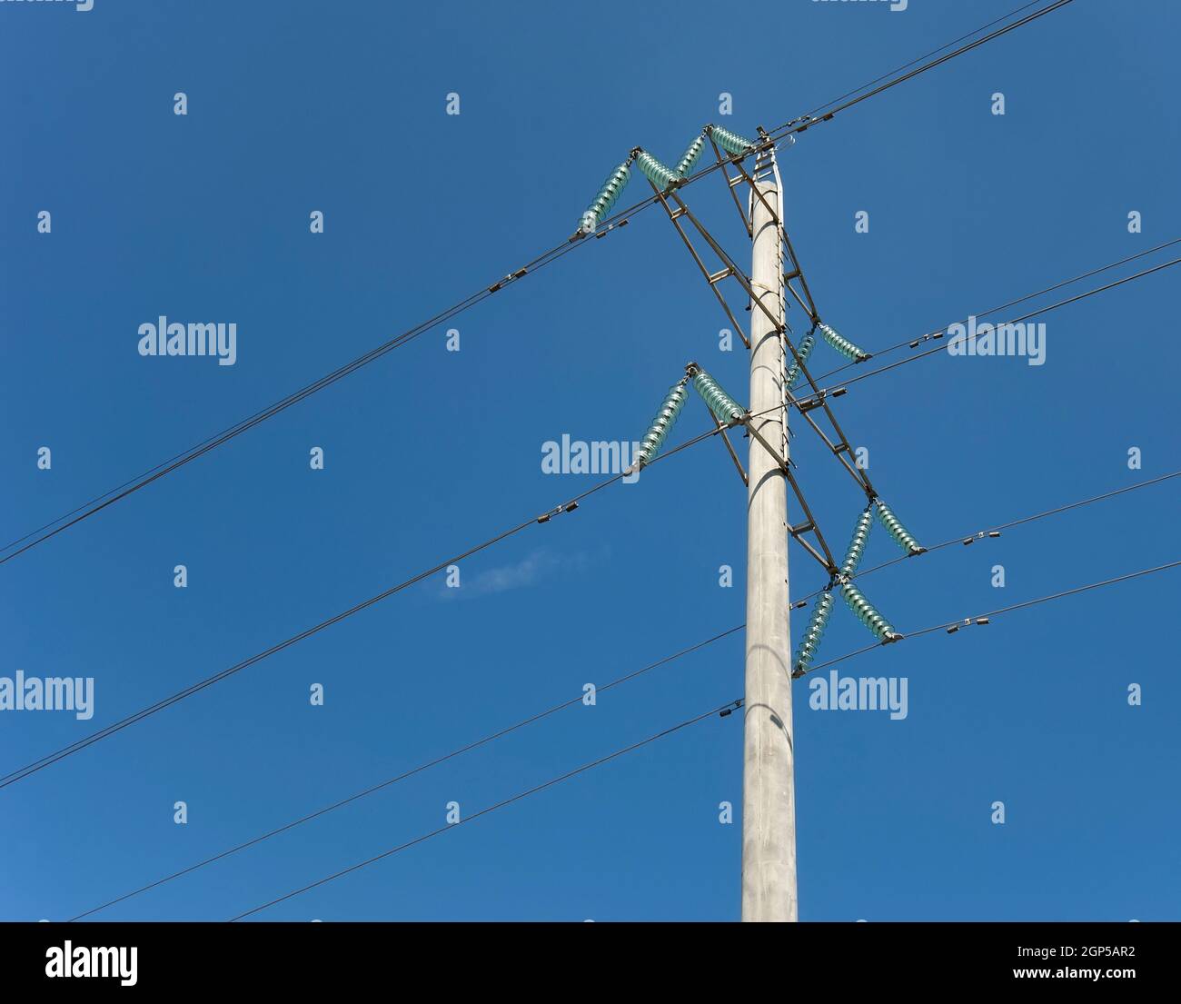Metal electric post against blue sky. Industry concept Stock Photo - Alamy