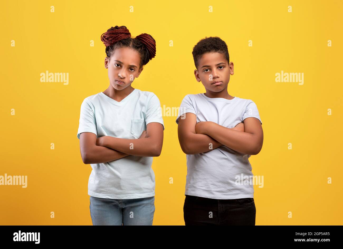 Annoyed black boy and girl with arms crossed on chests looking at ...