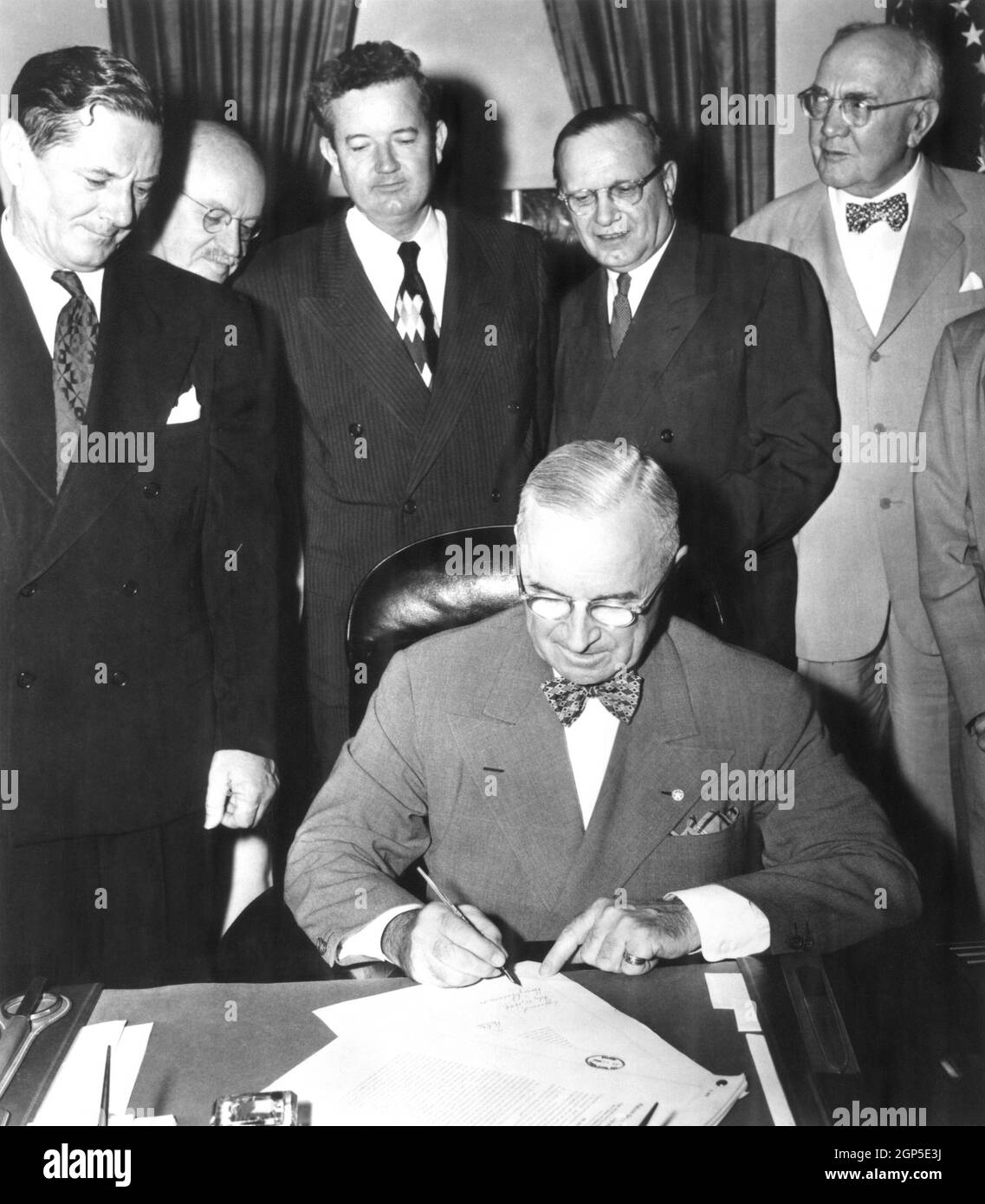 President Harry Truman signs the American Housing Act of 1949, on July ...