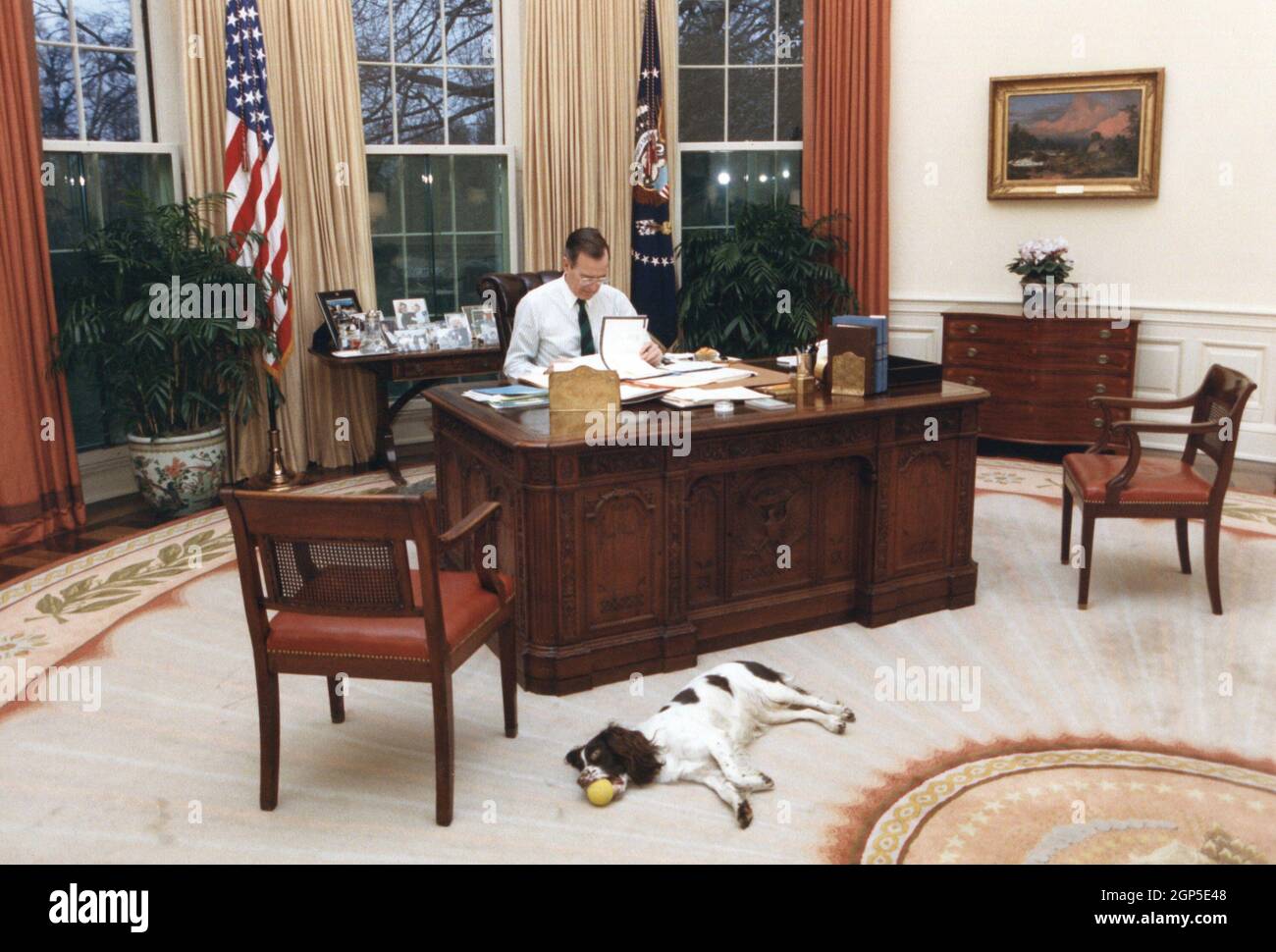 President George H.W. Bush, at Resolute Desk in Oval Office with the ...