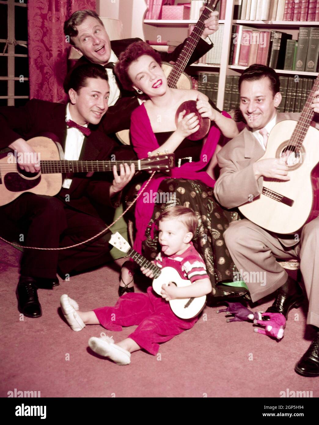 Eddie Albert and family with musicians. From center bottom, up: Eddie Albert Jr. (with ukulele ...
