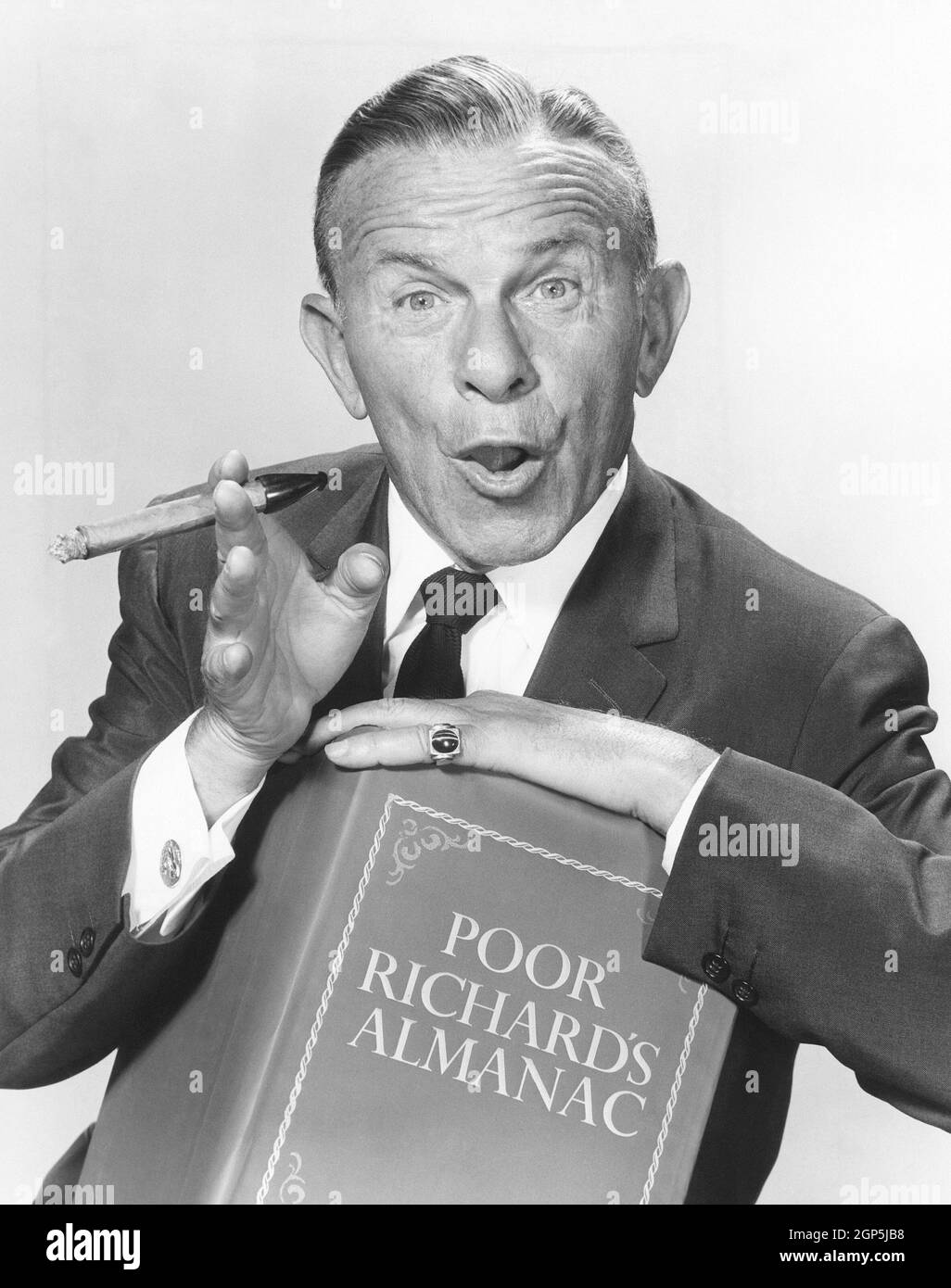George Burns, holding a copy of Poor Richard's Almanac, circa 1950s ...