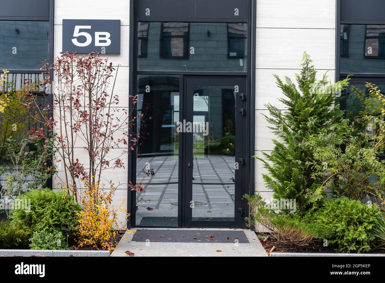 Outside solid glass door with building exterior Stock Photo - Alamy