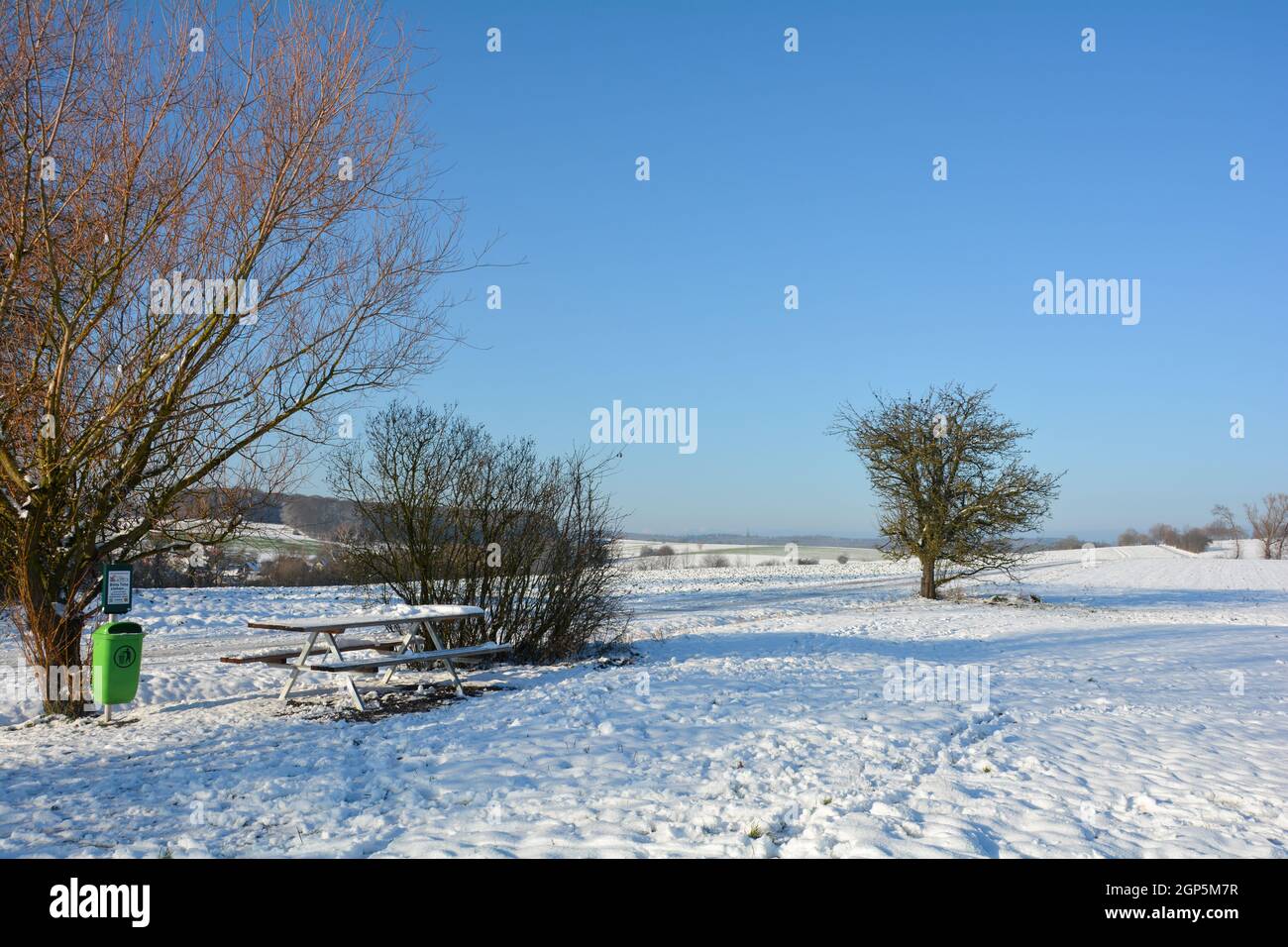 Landscape in the snow, with table and benches, with blue sky in Germany ...
