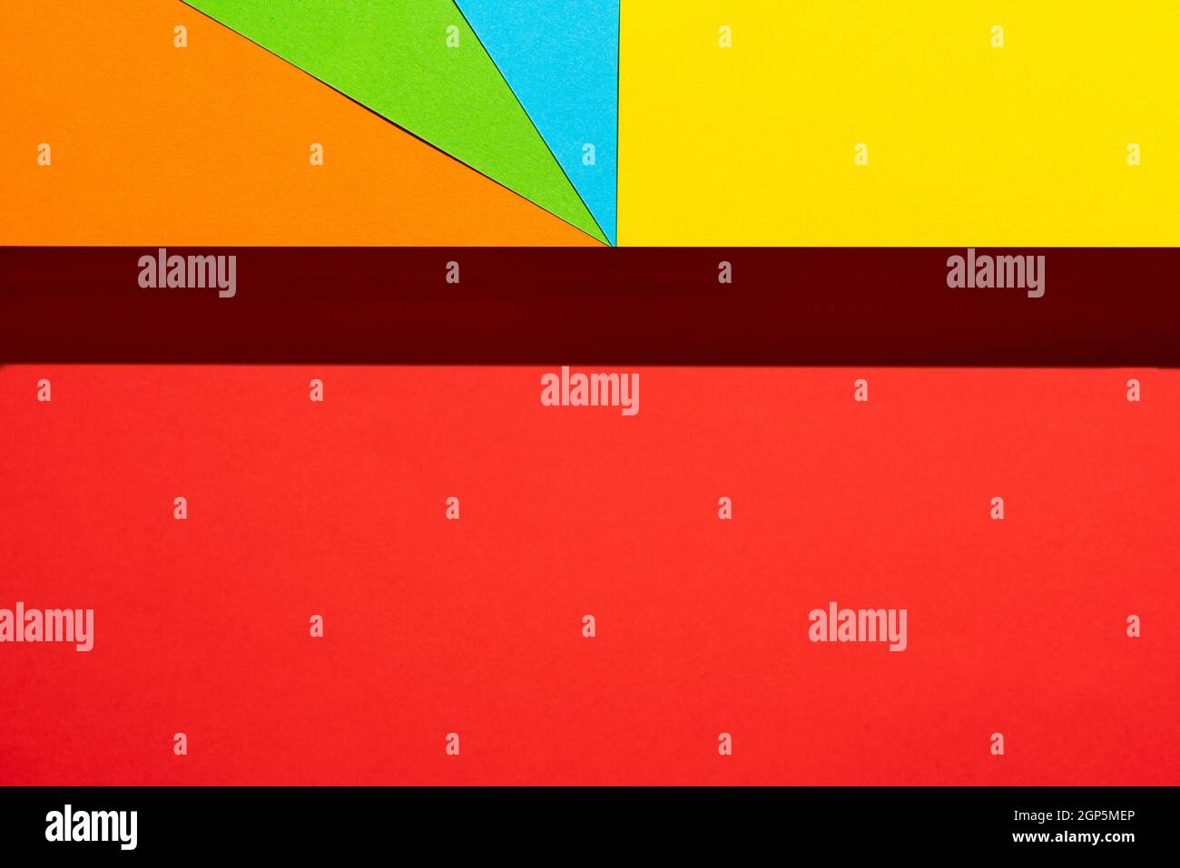sheets of colored paper with a shadow formed on the red surface Stock ...