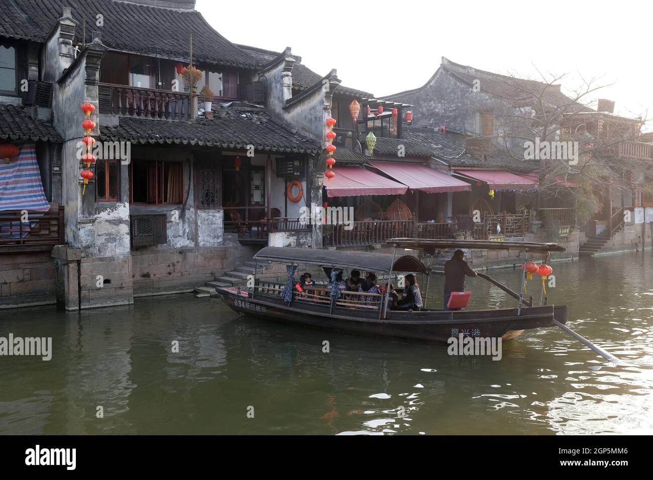 Tourist boats on the water canals of Xitang Town in Zhejiang Province ...